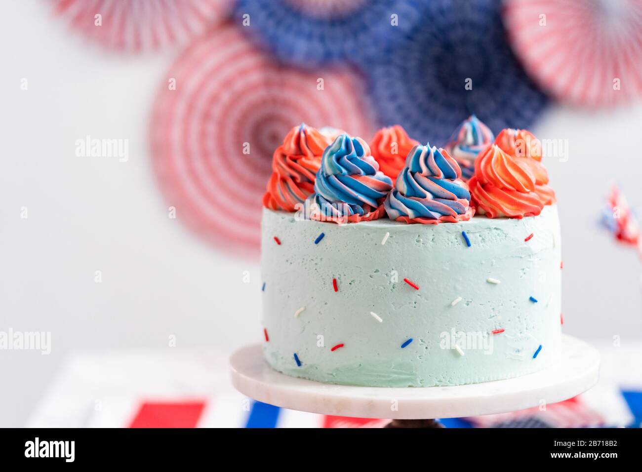 Red, white, and blue round vanilla cake with buttercream frosting for ...