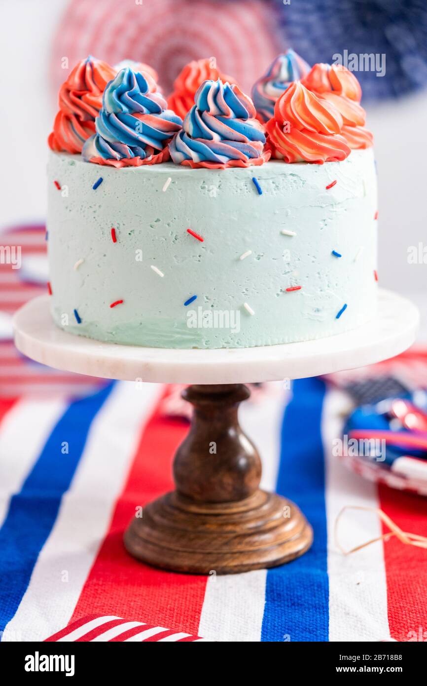 Red, white, and blue round vanilla cake with buttercream frosting for ...