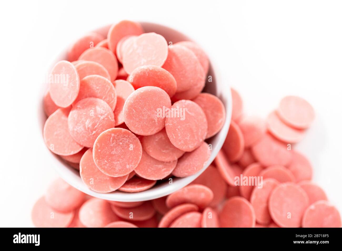 Pink round chocolate chips for melting chocolate shapes on a white ...