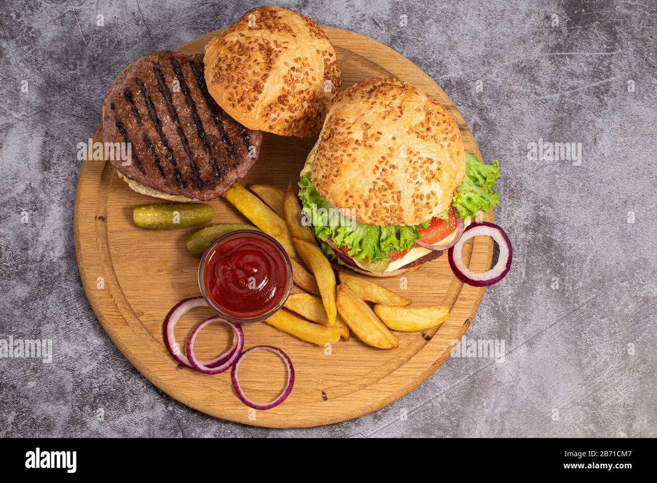 Tasty grilled home made burgers with beef, tomato, cheese, cucumber and ...