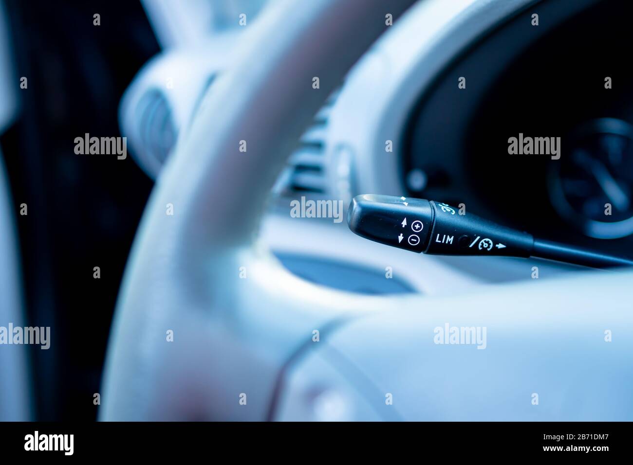 Close up automatic cruise control - tempomat command with blurred gages ...
