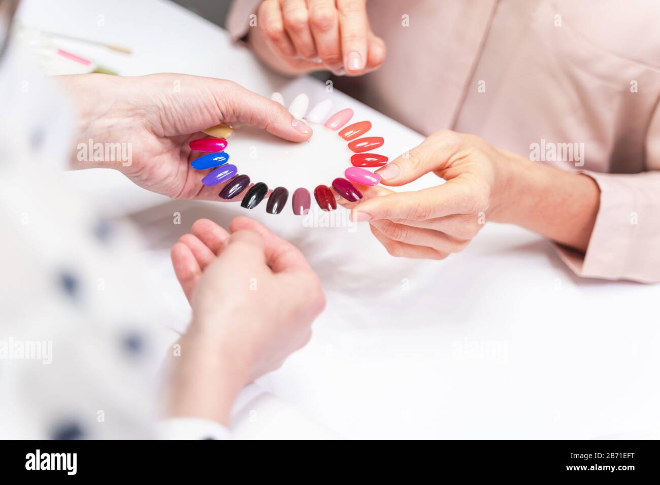 Close up of female hand that holding samples of polish Stock Photo - Alamy