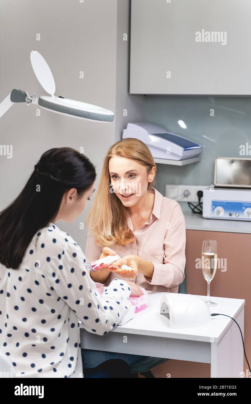 Positive delighted girls talking about their group mates Stock Photo ...