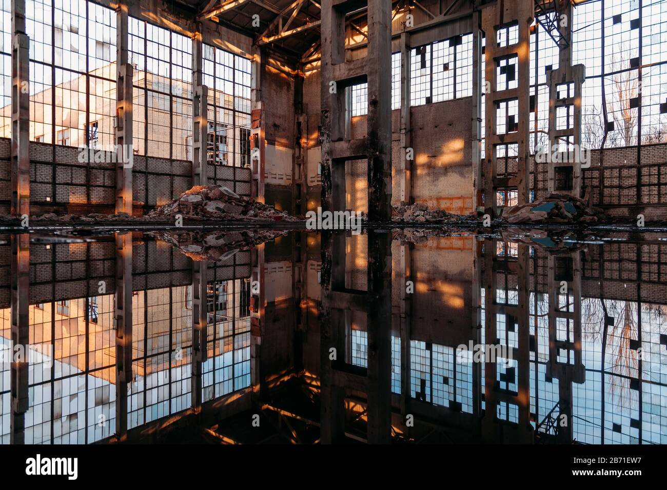 Inside of flooded dirty abandoned ruined industrial building with water ...