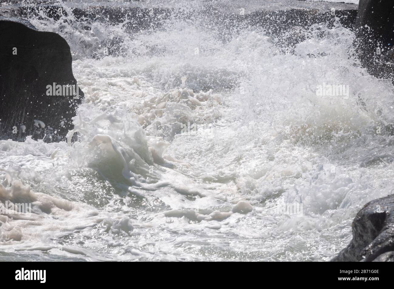 Frothy surf at Muriwai beach on New Zealand's north island Stock Photo ...