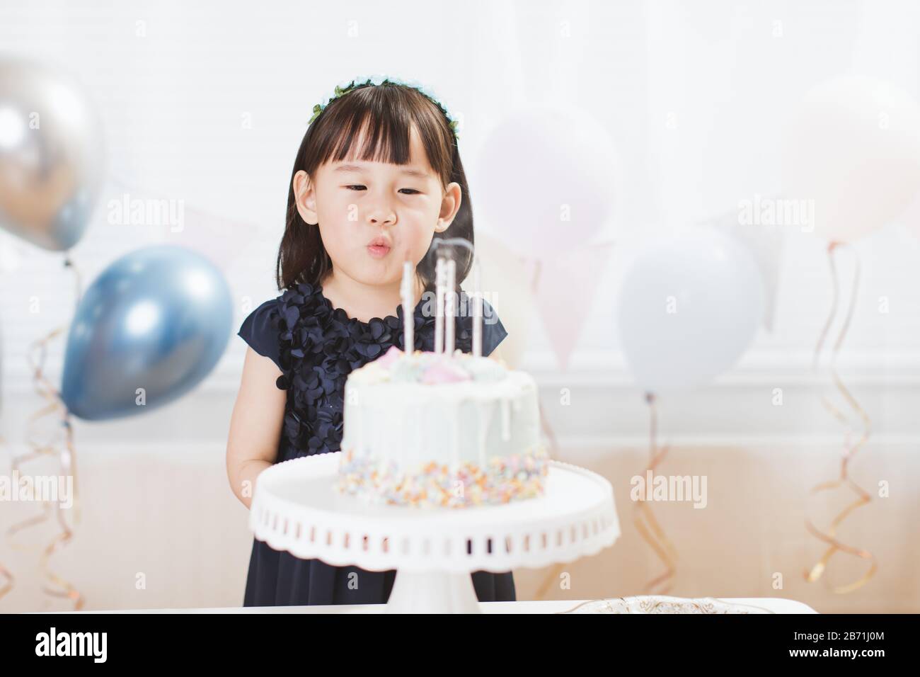 toddler girl celebrating her 4th birthday at home Stock Photo - Alamy
