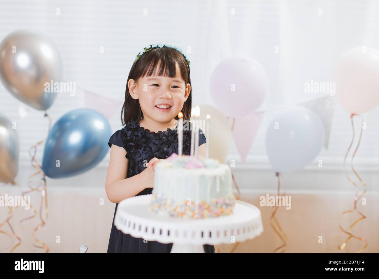 toddler girl celebrating her 4th birthday at home Stock Photo - Alamy