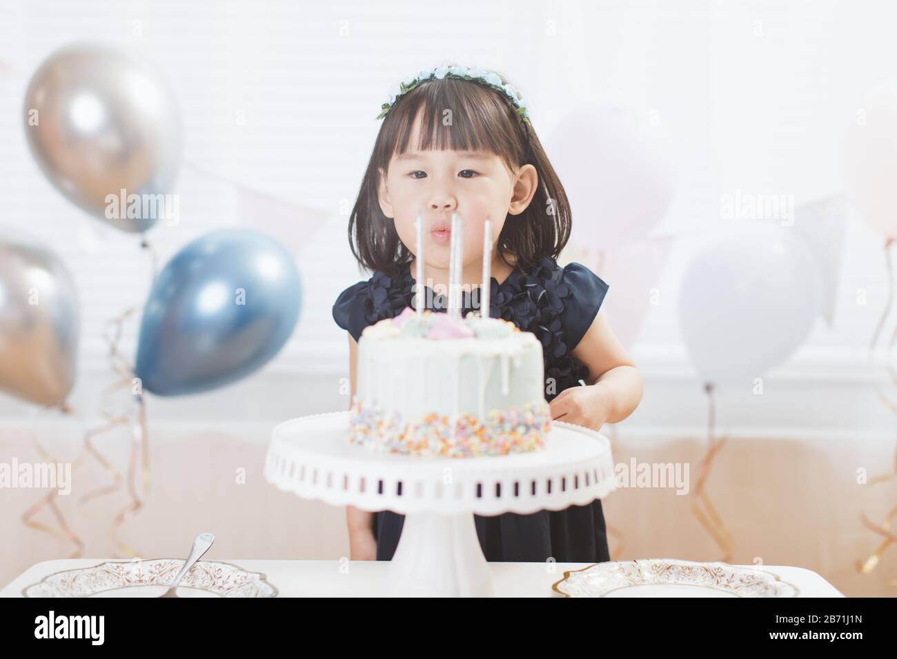 toddler girl celebrating her 4th birthday at home Stock Photo - Alamy