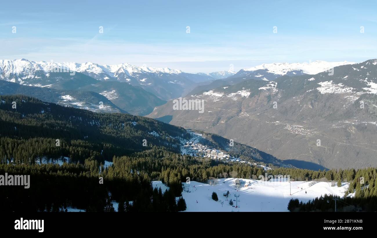 Aerial winter scene of alpine snowy mountain peaks and dark spruce ...