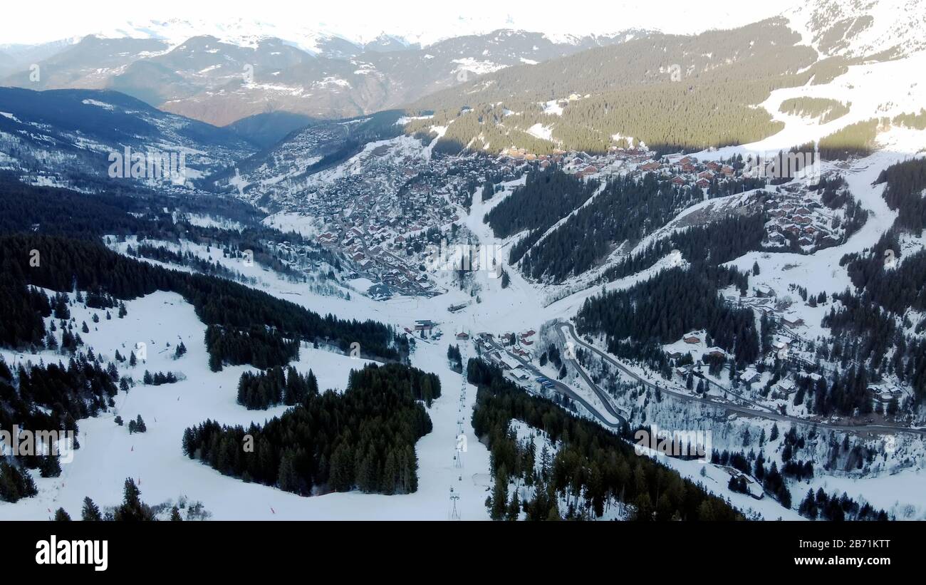 Aerial winter scene of alpine snowy mountain peaks and dark spruce ...