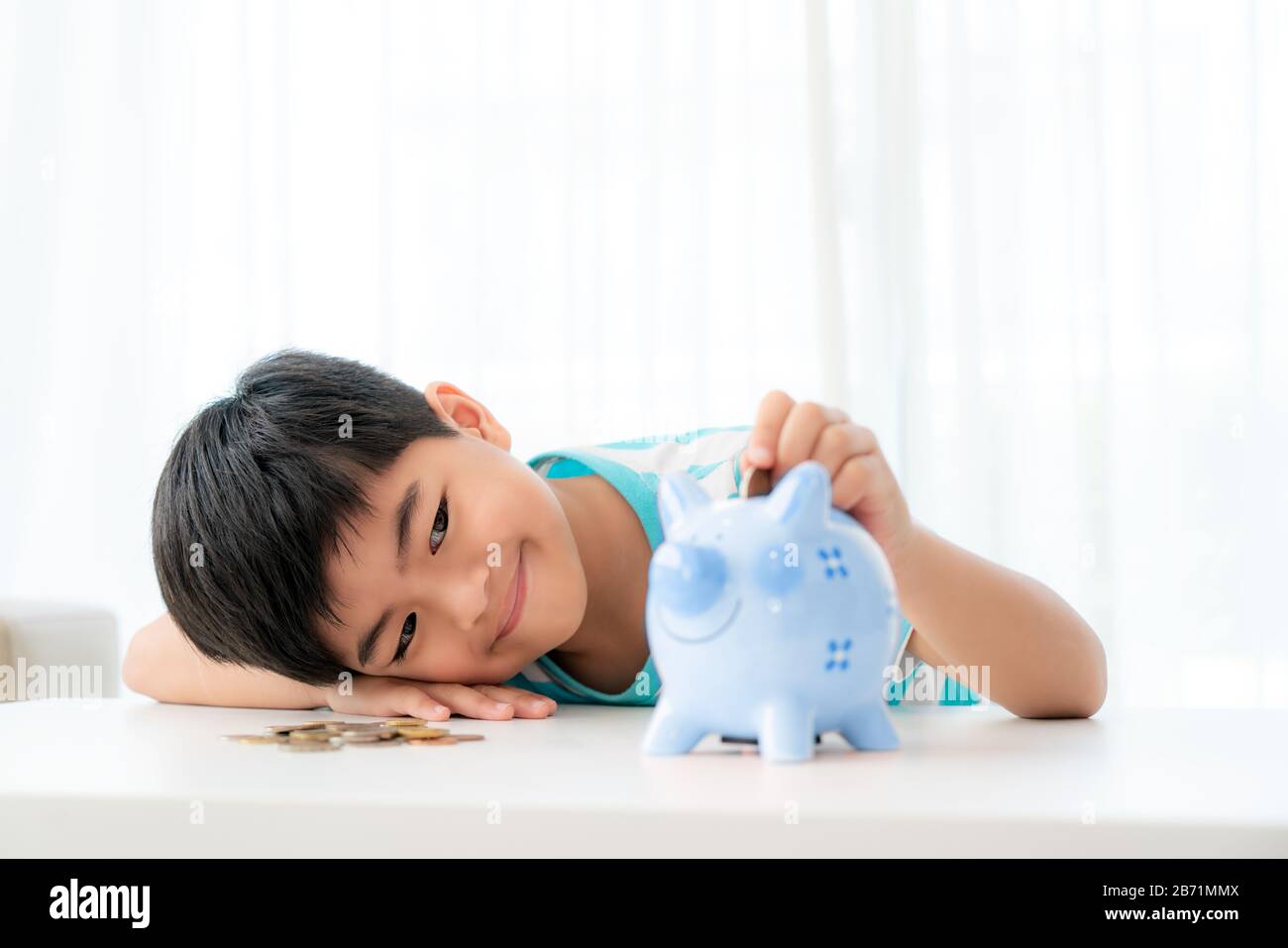 Boy counting coins hi-res stock photography and images - Alamy