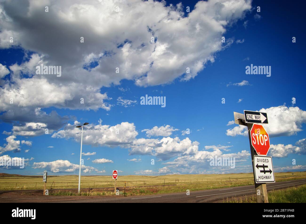 Country road intersection with pretty blue sky and clouds Stock Photo ...