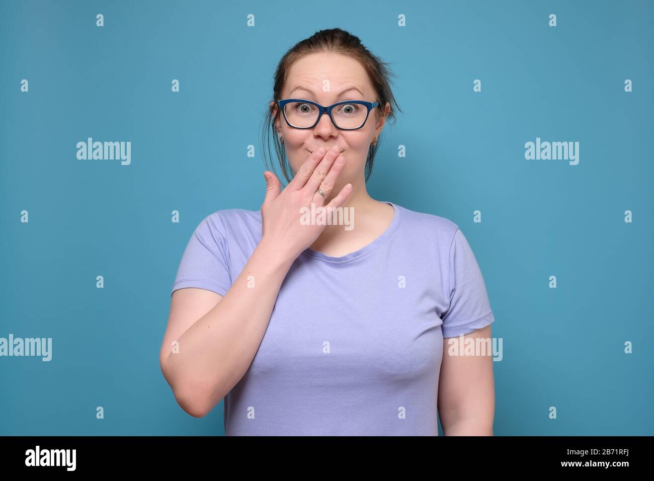 Oops hand signal. Pretty young caucasian woman with glasses with hand ...