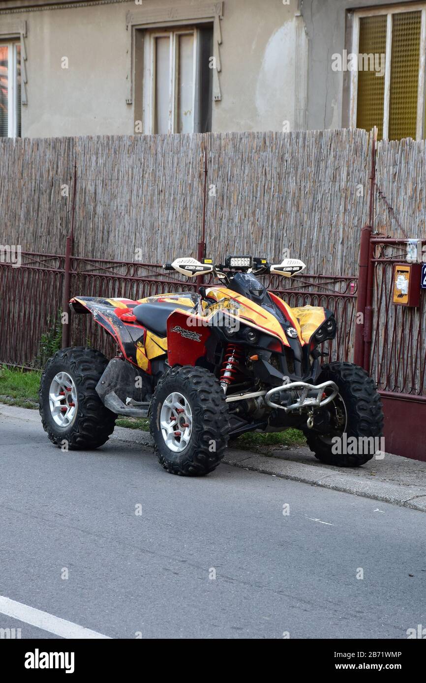 A colorful quad parked next to the fence Stock Photo - Alamy