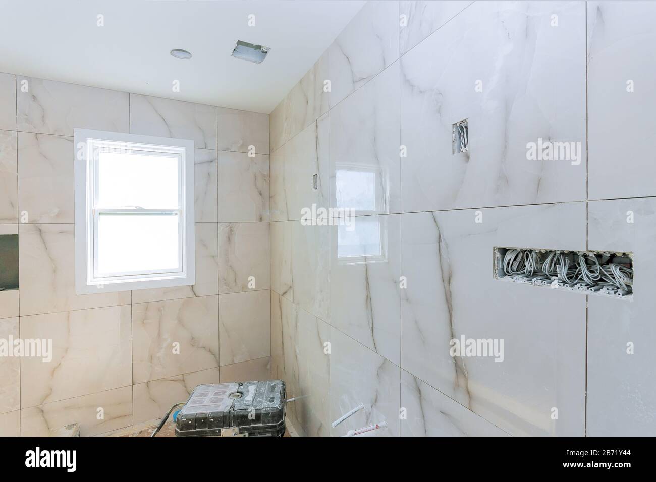 Construction work installing ceramic tile on reconstruction of bathroom ...