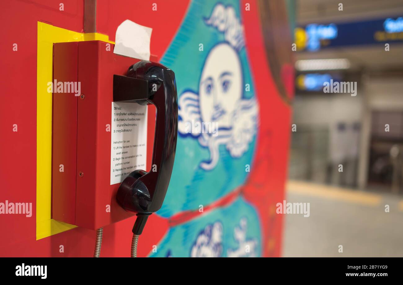 Emergency call on the wall with the blured background at the subway in ...