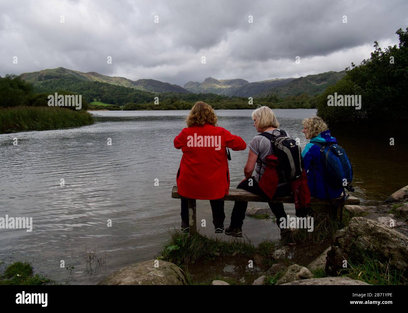 Ladies taking a break with a lake view Stock Photo - Alamy