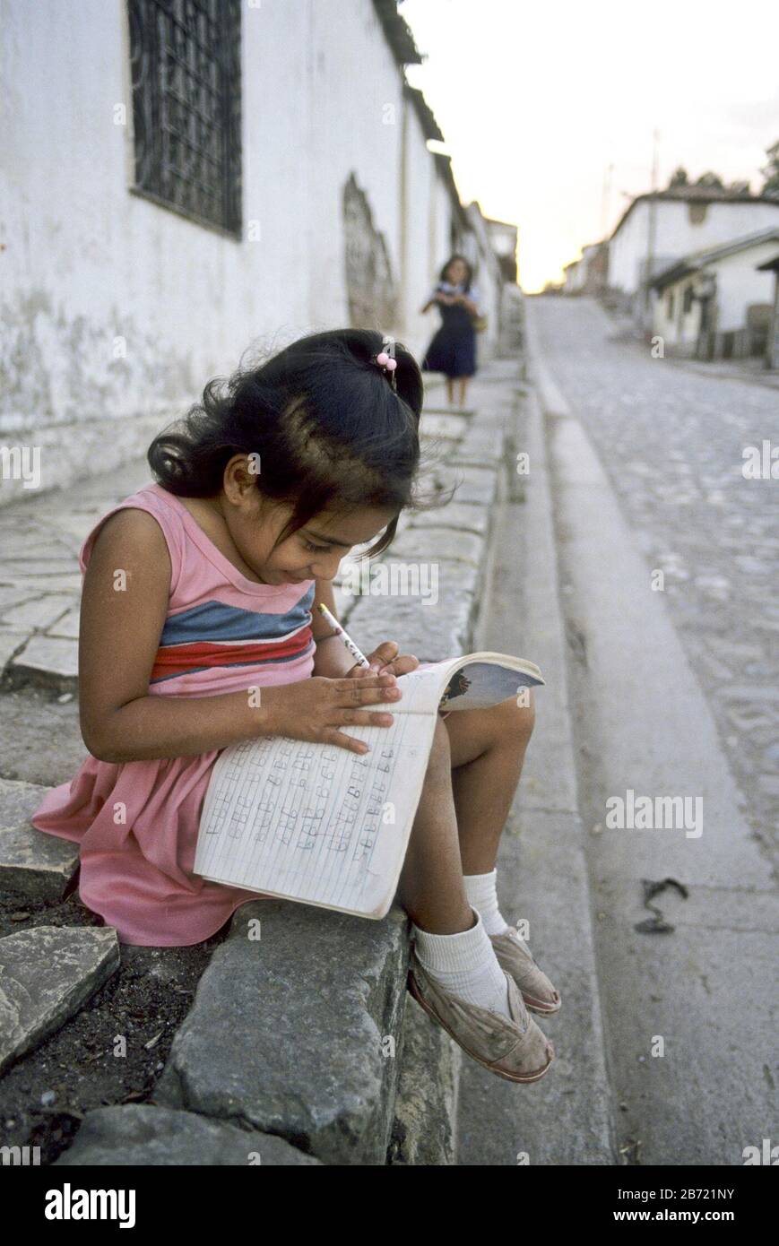 Copan Ruinas, Honduras: Little girl writing with her left hand in ...