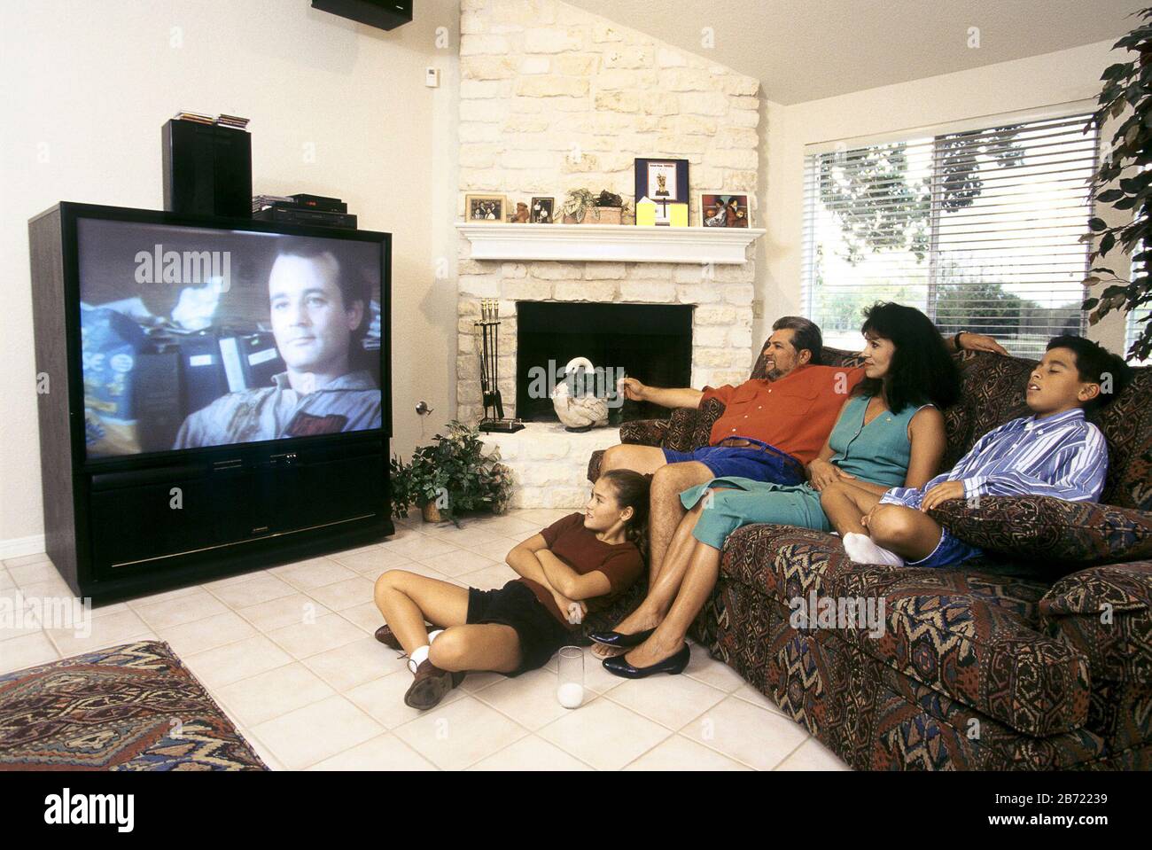 Hispanic Family Watching Tv Family Movie Day Stock Photos, Images And