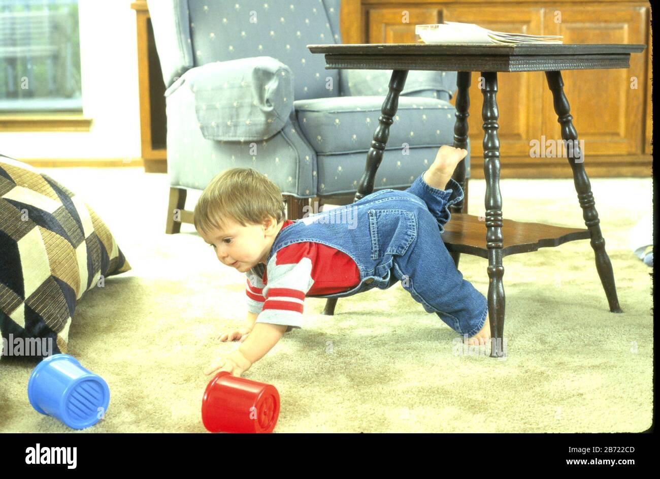 Austin Texas USA, 1995: Ten-month-old baby boy learning to stand up ...