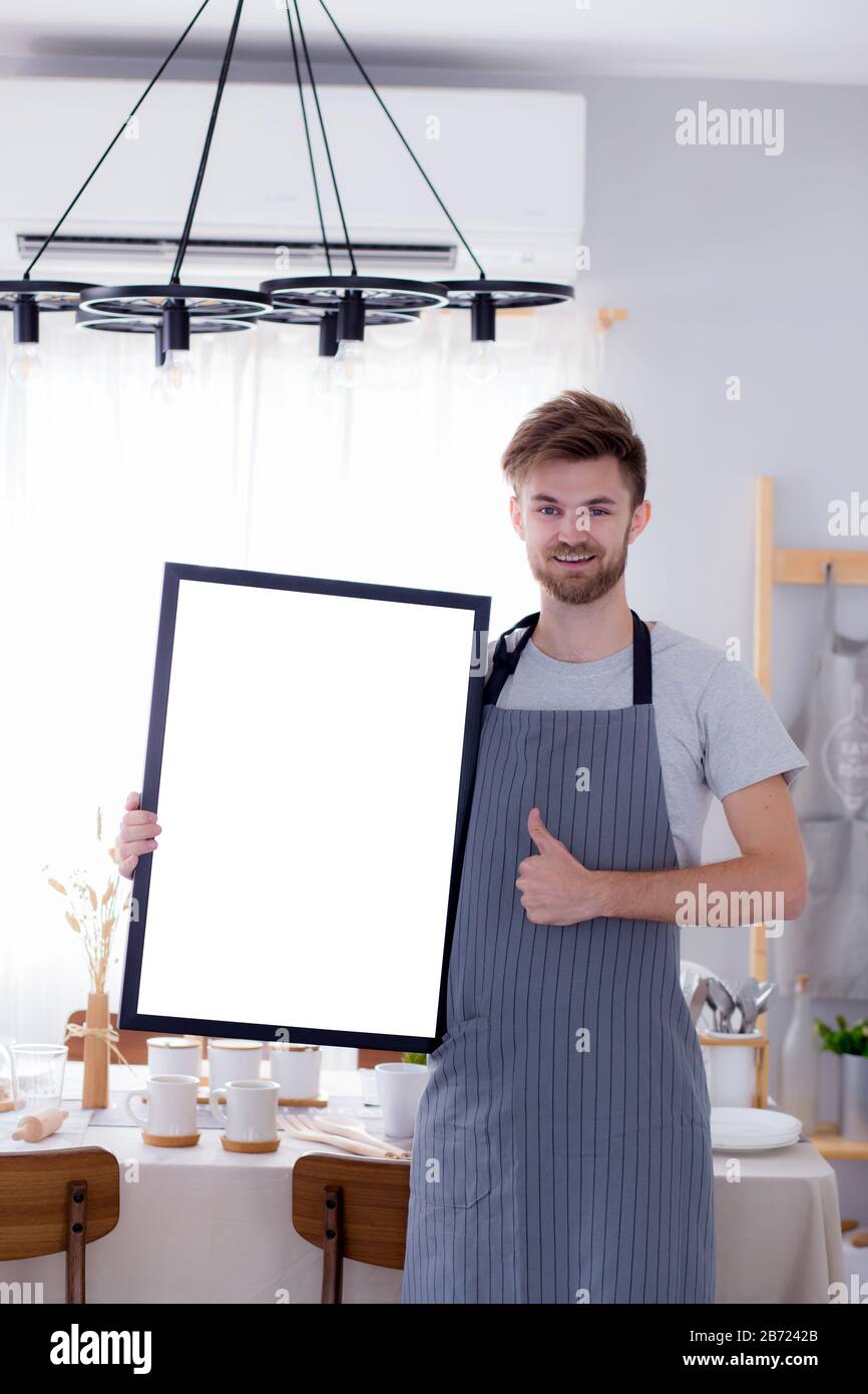 handsome chef showing blank empty board menu sign for restaurant menu ...