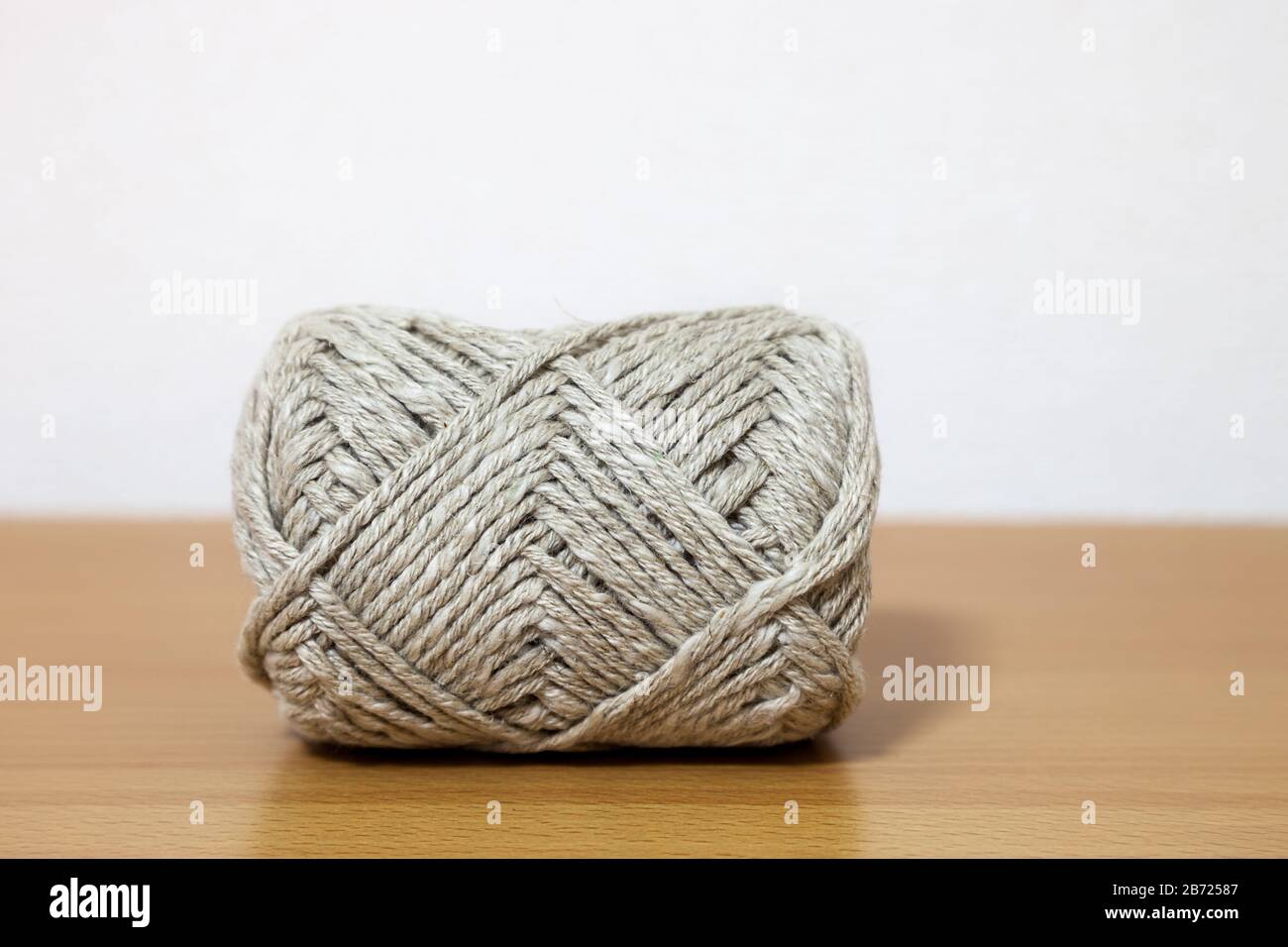 Ball of brown yarn on white background Stock Photo - Alamy
