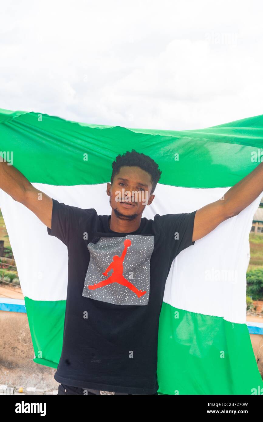 Proudly Nigeria. Photo of a young Africa man Holding his Country flag ...