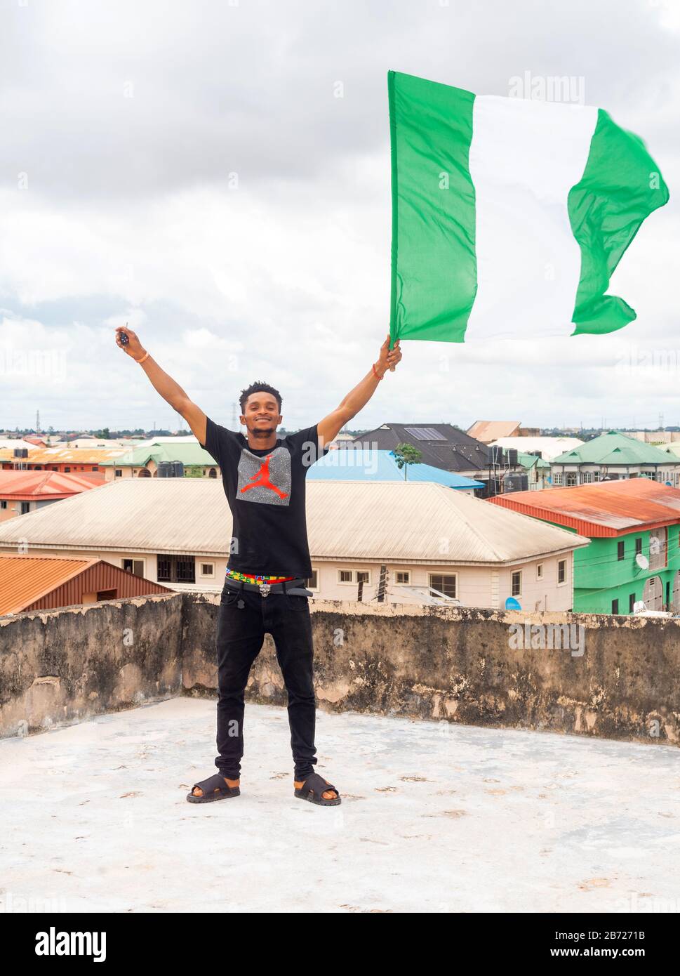 Proudly Nigeria. Photo of a young Africa man Holding his Country flag ...