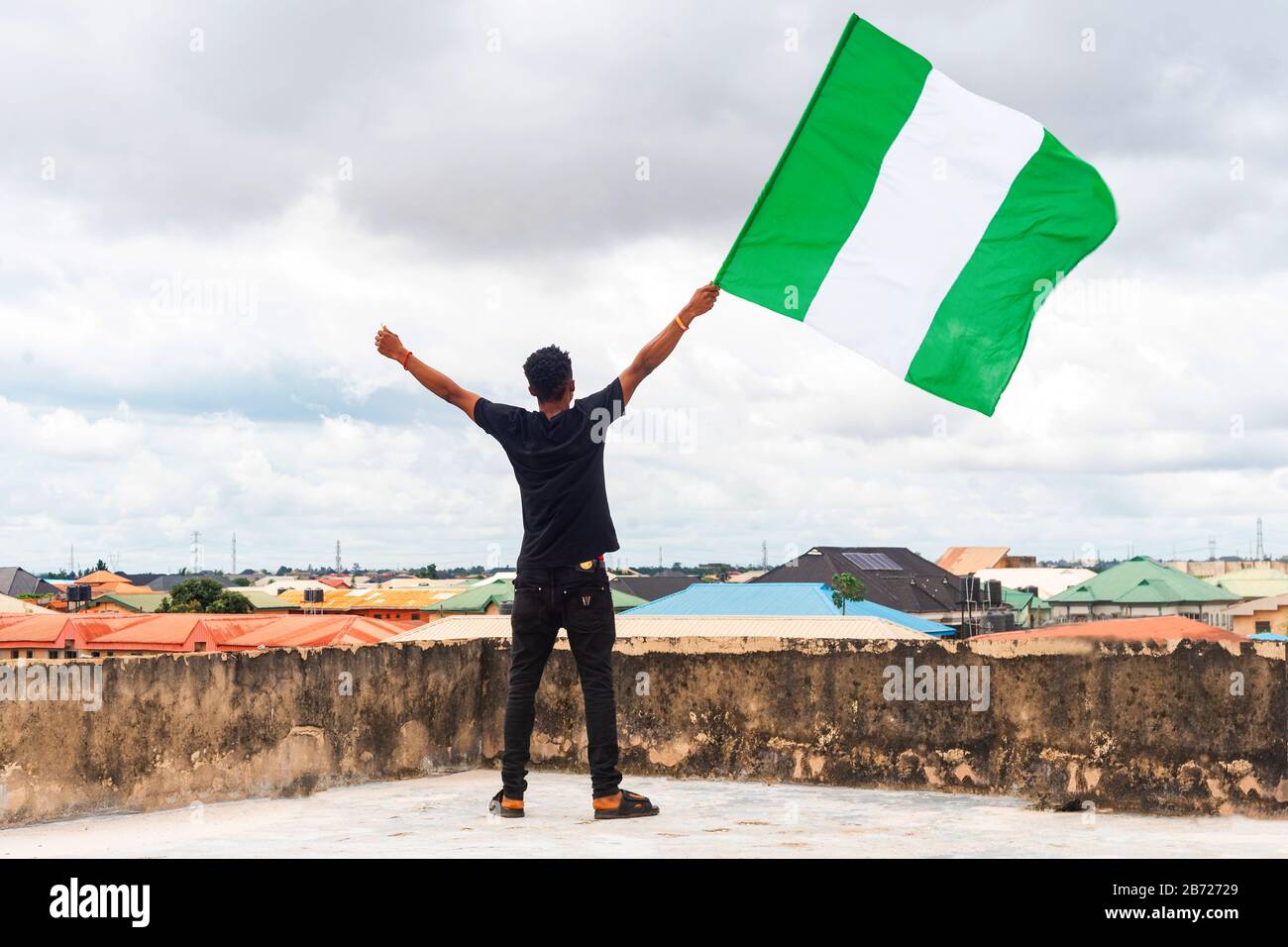 Proudly Nigeria. Photo of a young Africa man Holding his Country flag ...