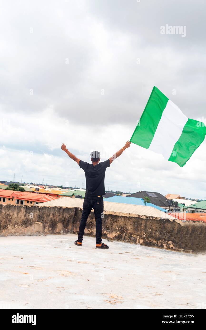 Proudly Nigeria. Photo of a young Africa man Holding his Country flag ...