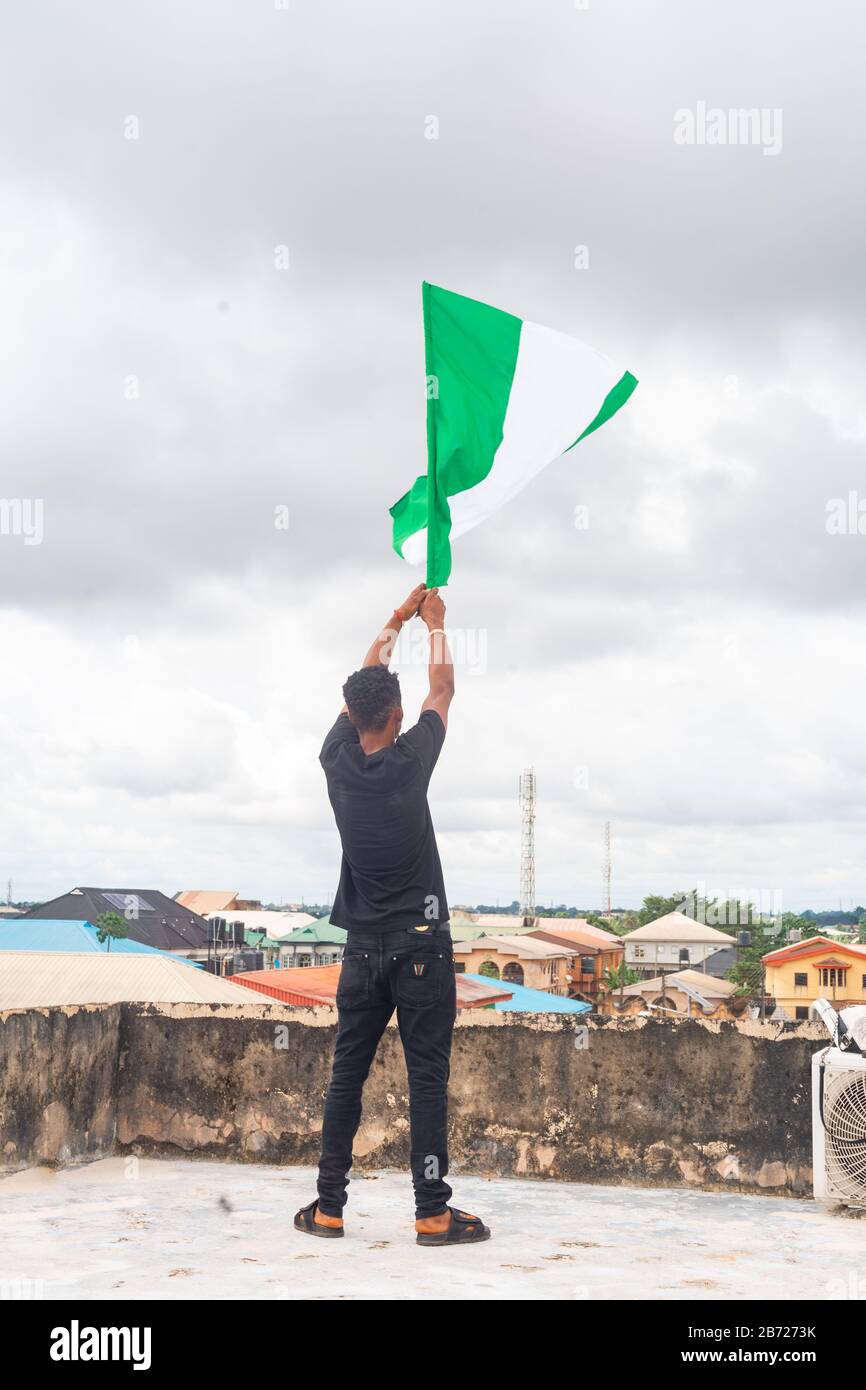 Proudly Nigeria. Photo of a young Africa man Holding his Country flag ...