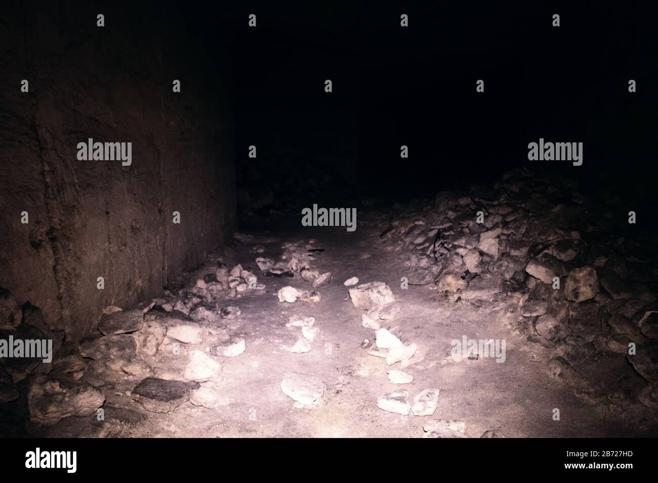 Old underground passage, dungeon, catacombs lined with stones and slabs ...