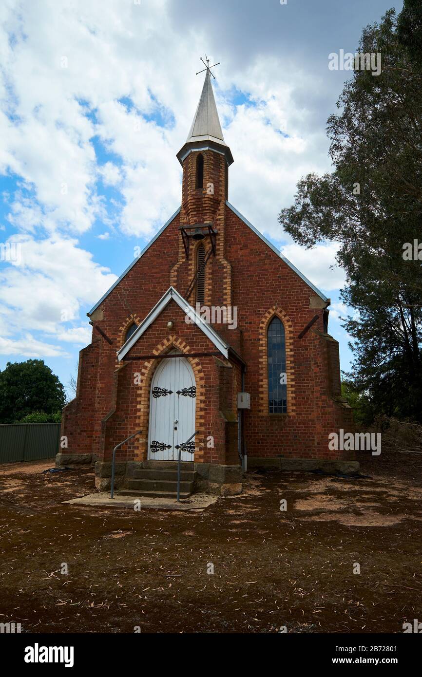 Exterior view of an old, red brick rural, desolate, small church and ...