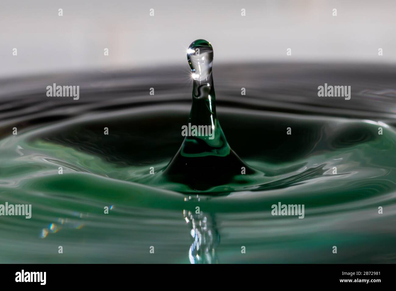 Water drops falling from above and splashing into a bowl of water Stock ...