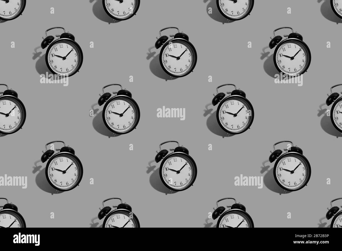 Many black classic style alarm clock with hard shadow isolated on ...