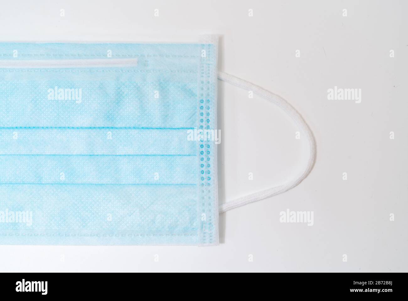 Surgical mask with rubber ear straps. Typical 3-ply surgical mask to ...