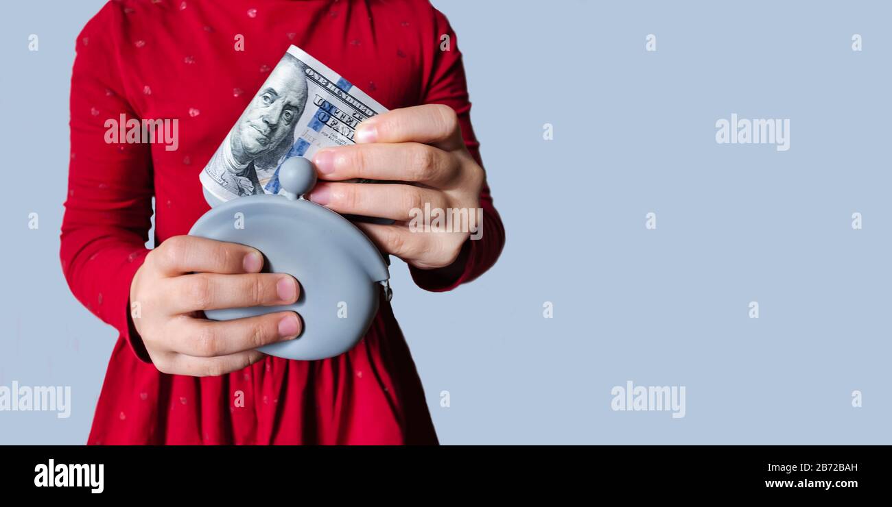 Child hand puts money in a wallet. Kid take dollars from parent ...