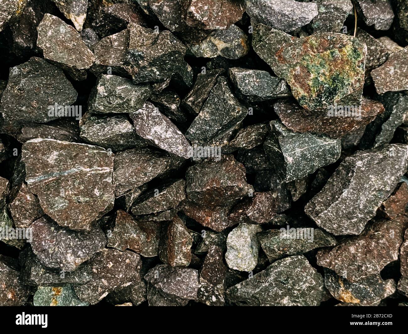 Rough stones, crushed stone, granite gravel close-up. The rough texture ...