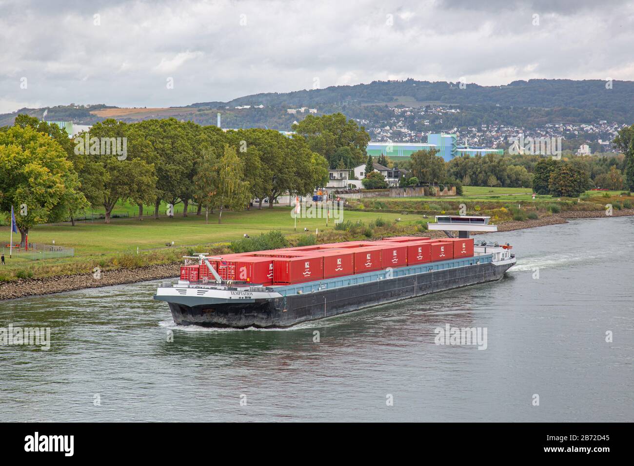 top view from a bridge across the river rhine onto a container ship ...