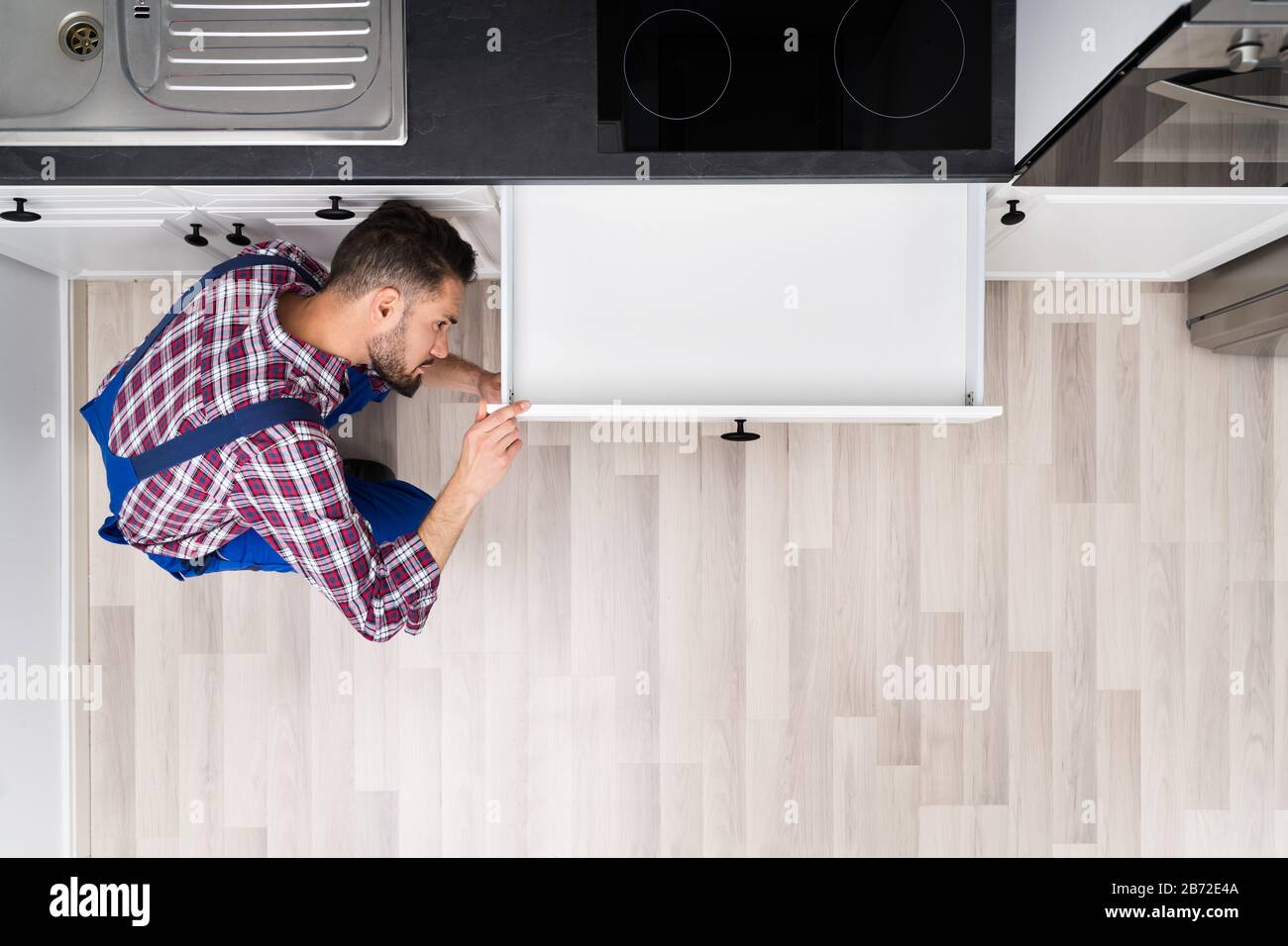 Close-up Of A Young Male Carpenter Installing Drawer With Screwdriver ...