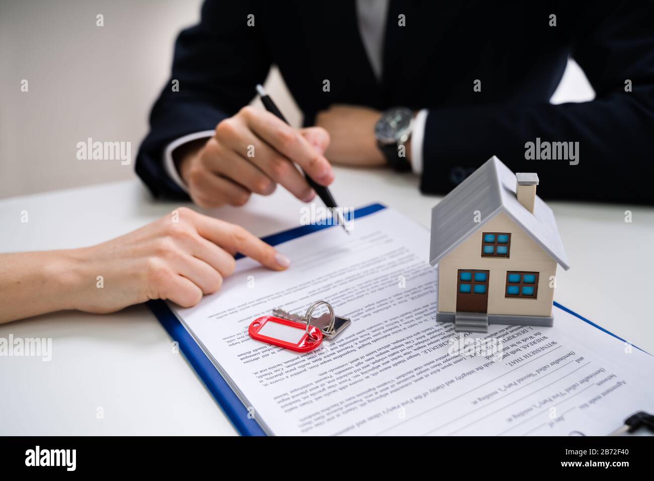 Two people signing business contract hi-res stock photography and ...