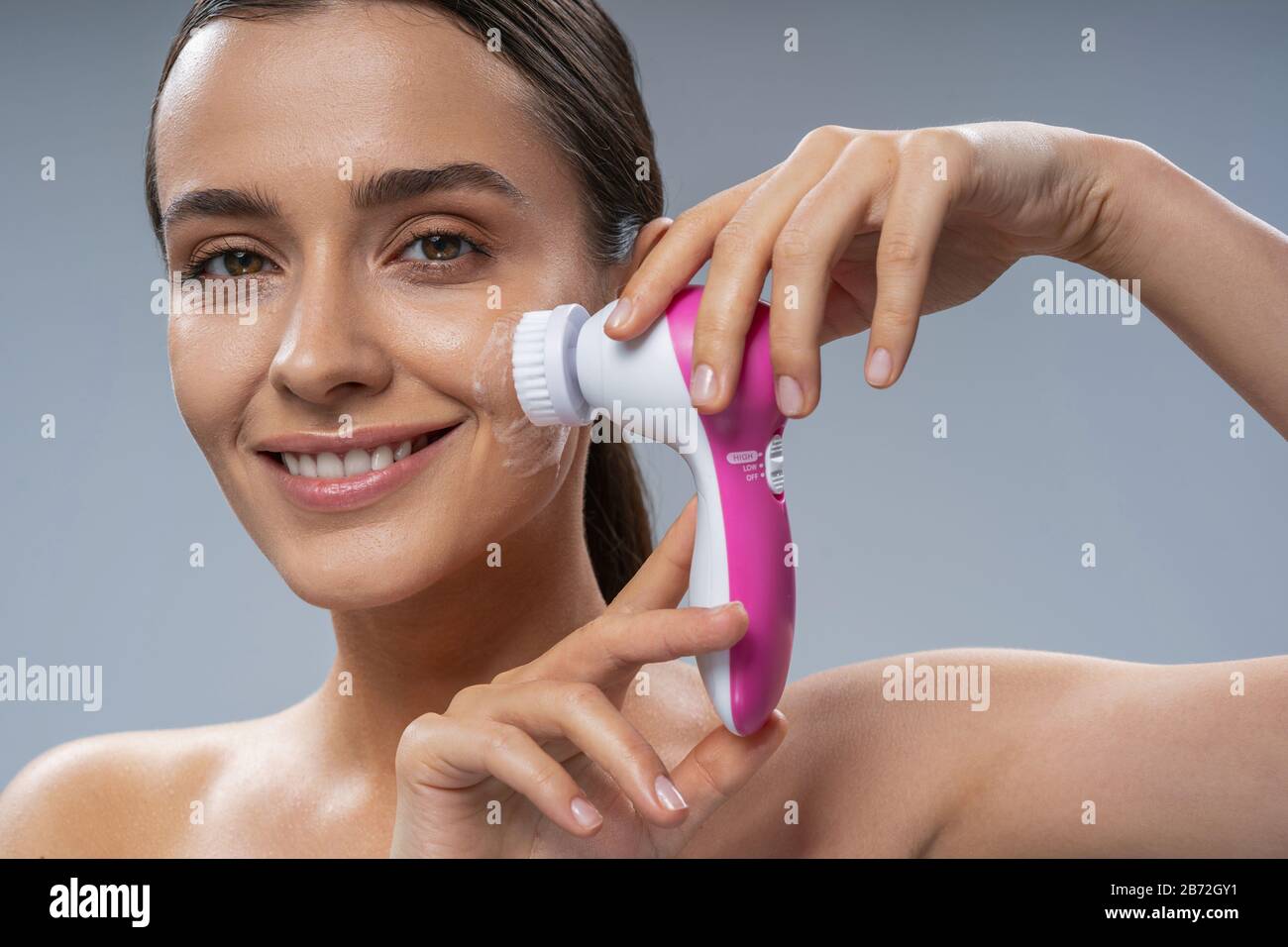 Woman electric brush face hi-res stock photography and images - Alamy