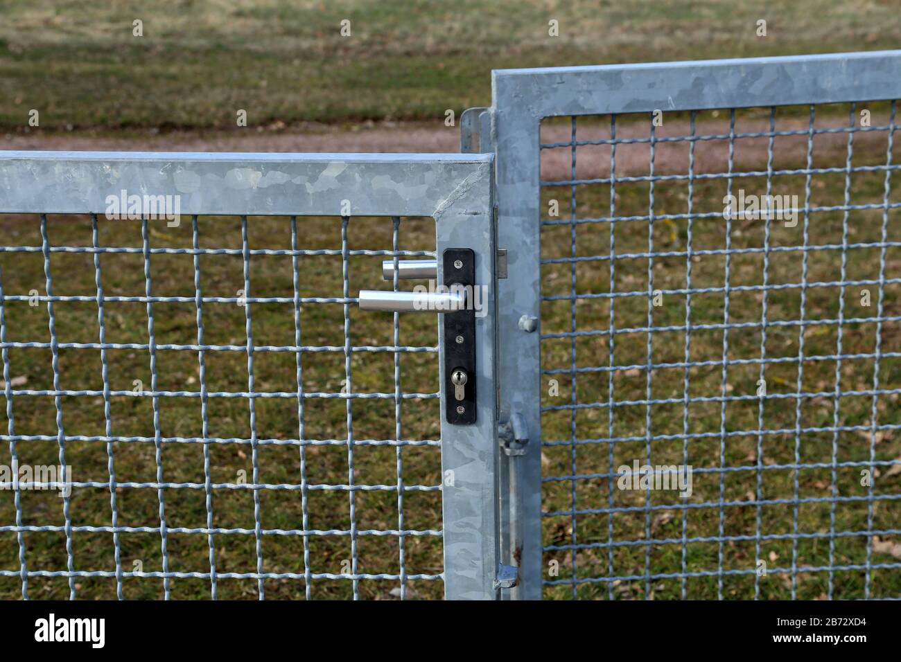 Metal mesh gate with internal lock and handle Stock Photo - Alamy