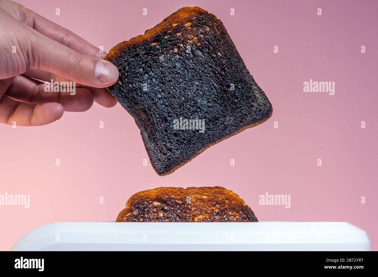 Pieces of bread pop-up from breadtoaster. burnt bread Stock Photo - Alamy