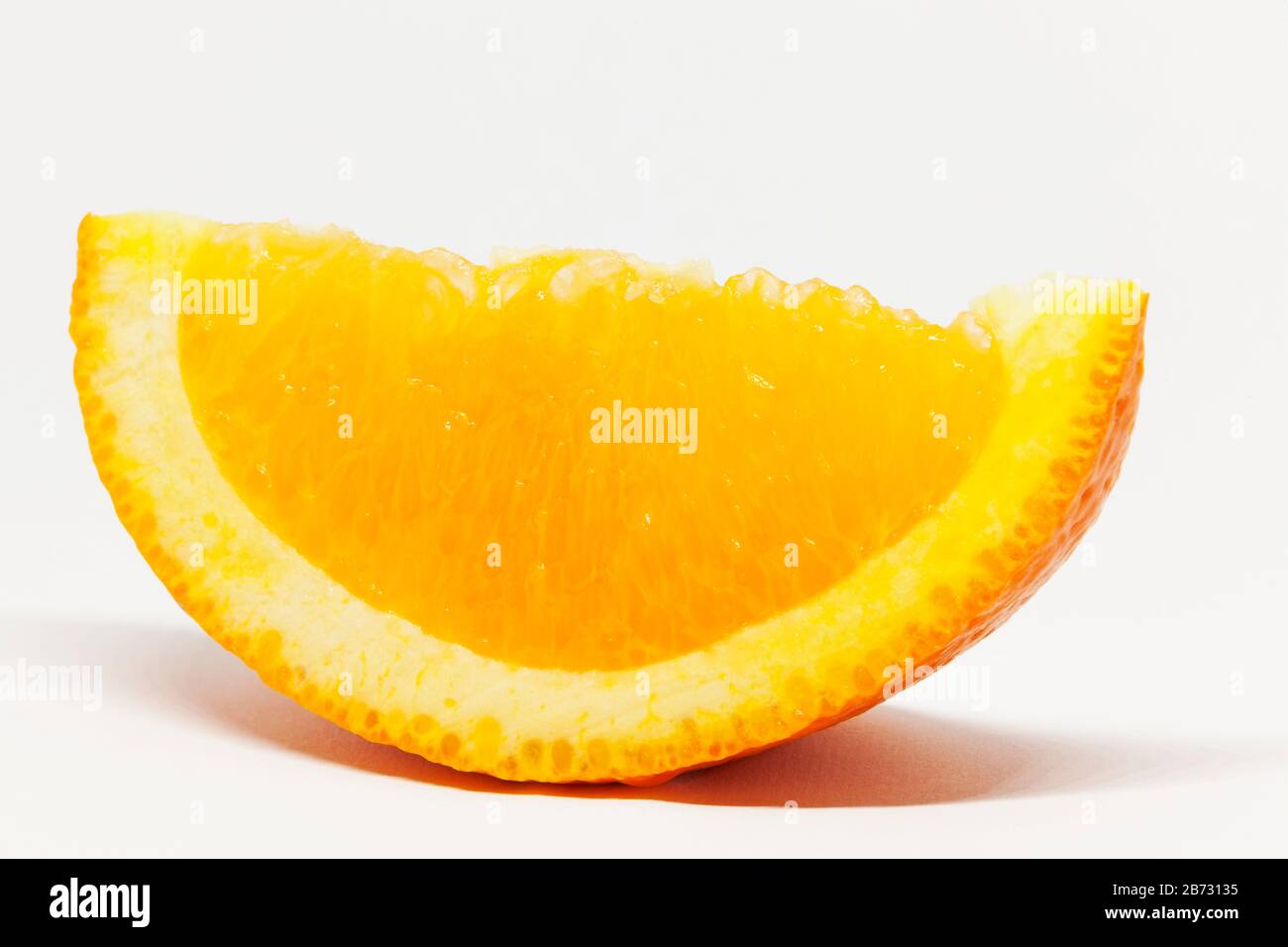 juicy orange sliver on white background Stock Photo - Alamy
