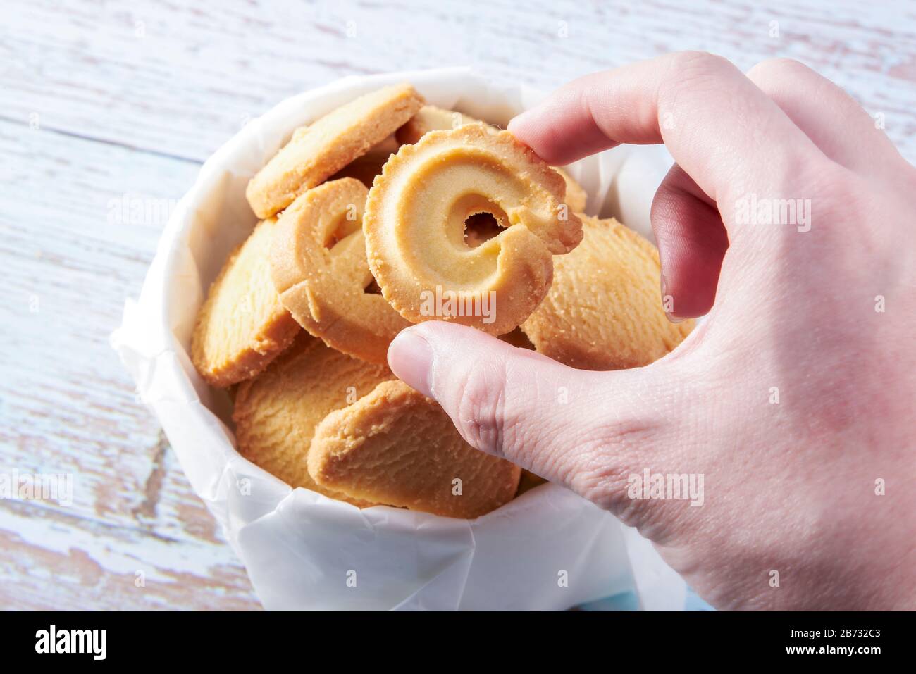 Pick up a bowl of cookies with one hand Stock Photo - Alamy