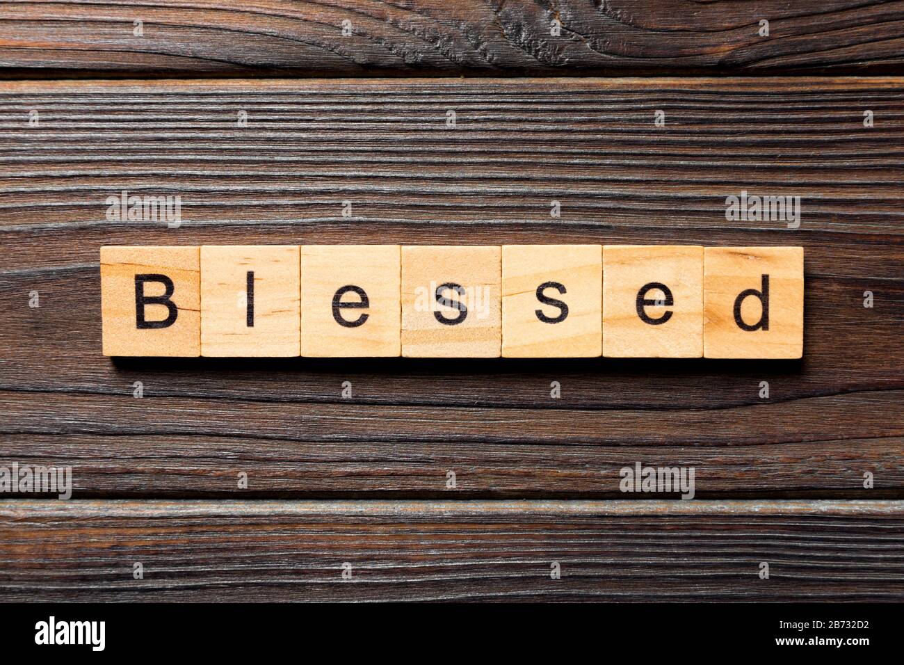 Blessed word written on wood block. Blessed text on wooden table for ...