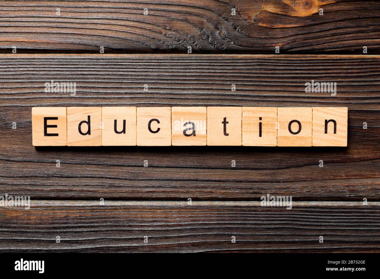 Education word written on wood block. Education text on wooden table ...