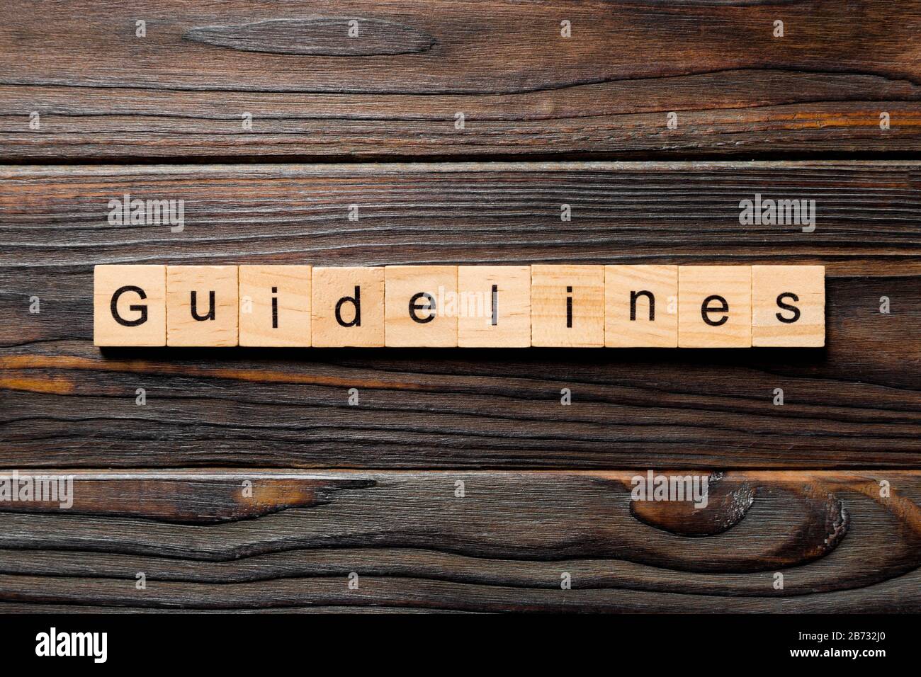 Guidelines word written on wood block. Guidelines text on table ...