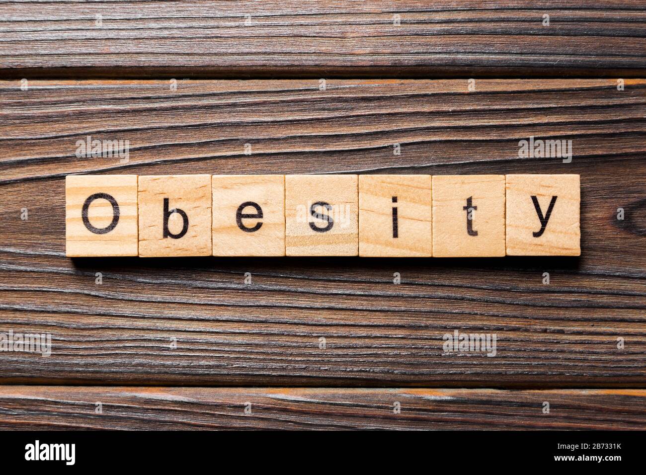 Obesity word written on wood block. Obesity text on wooden table for ...